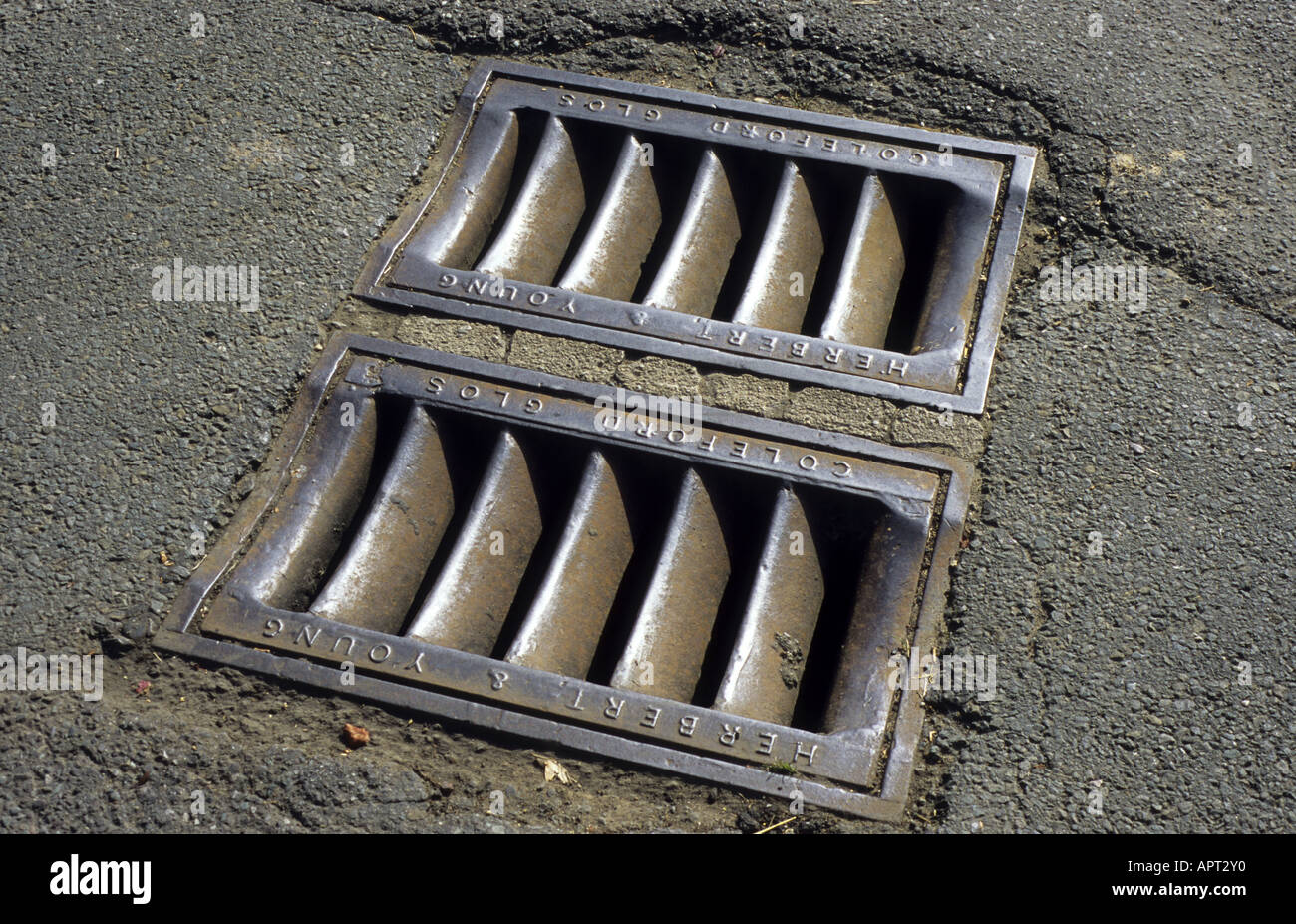 Metal drains in road Stock Photo - Alamy