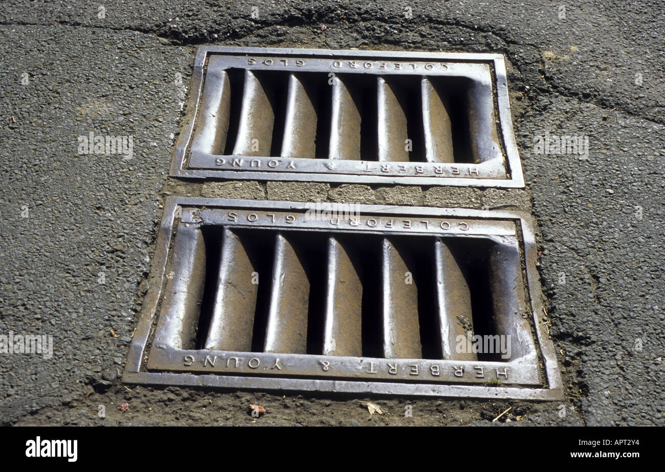 Metal drains in road Stock Photo - Alamy