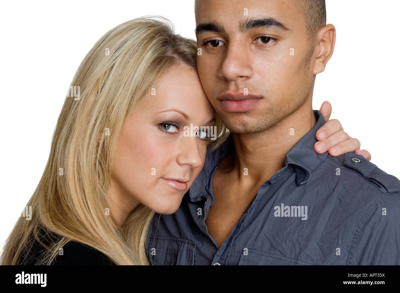 young mixed race couple cuddling looking sad Stock Photo - Alamy