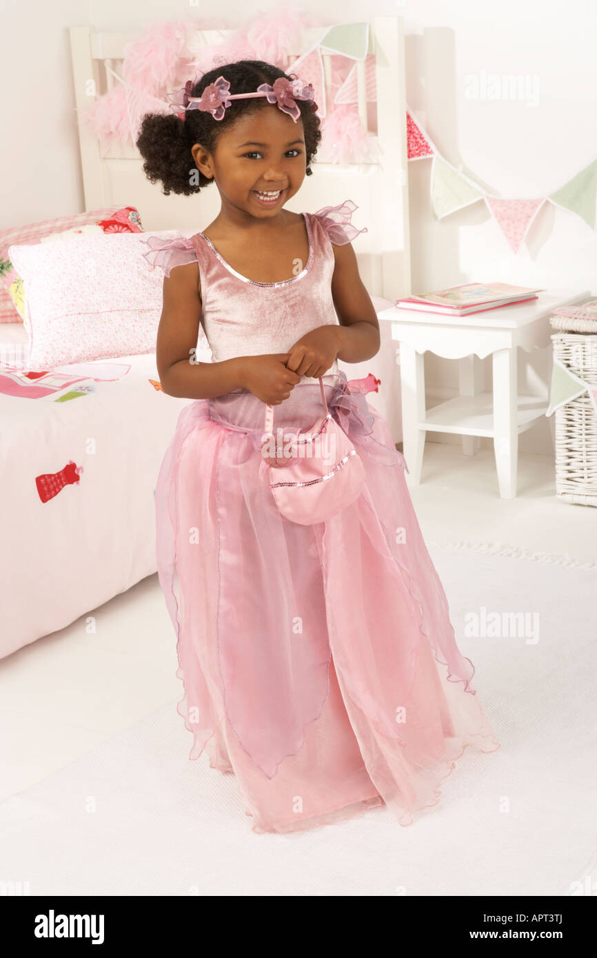 a girl plays dressing up in her bedroom, she is dressed as a princess ...