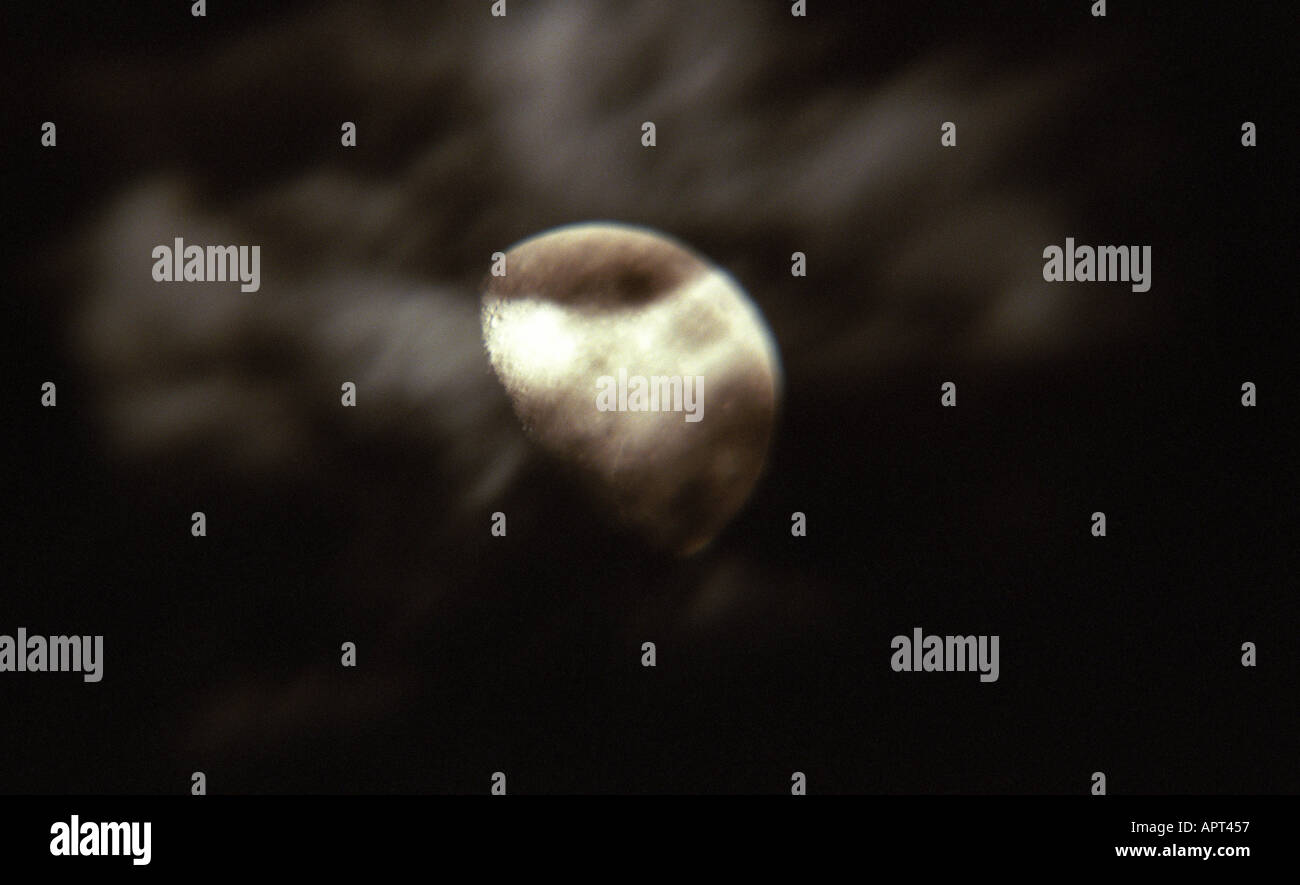 Clouds pass over the moon at night. close-up half moon Stock Photo - Alamy
