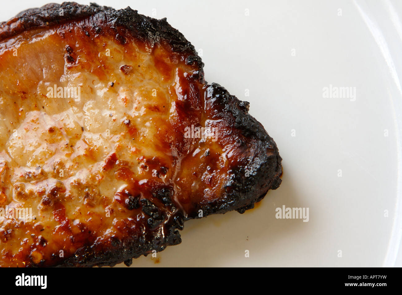 Succulent Marinaded Pork Chop on white plate Stock Photo - Alamy