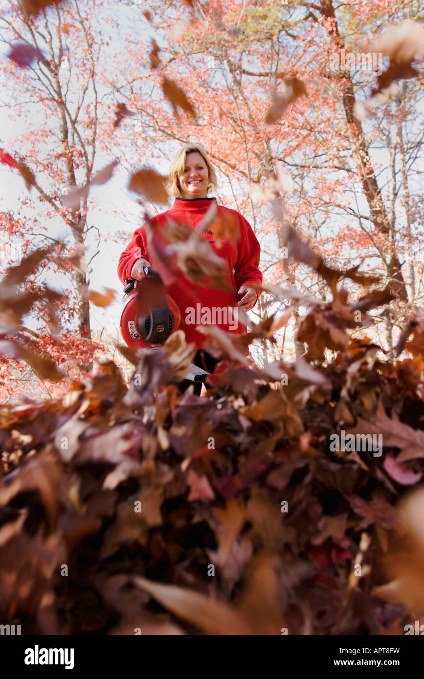 Woman blowing leaves leaf blower hi-res stock photography and images ...