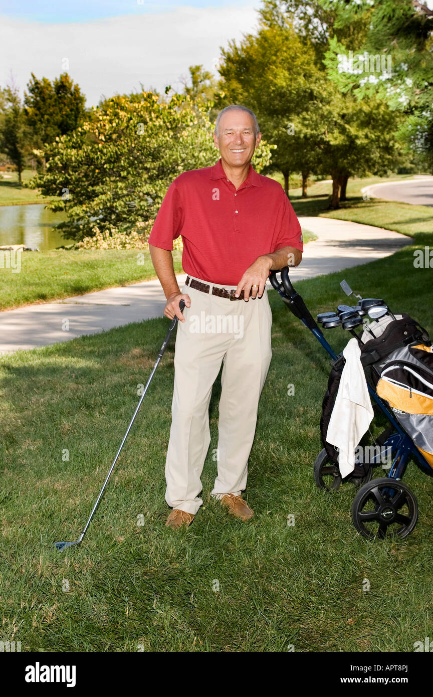 mature man with golf club on golf course Stock Photo - Alamy