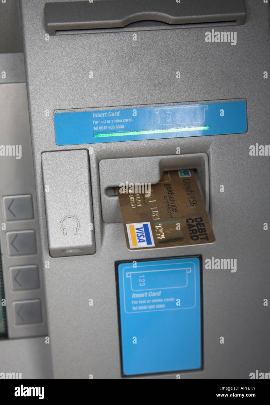Gold debit card in bank cash point machine Stock Photo - Alamy