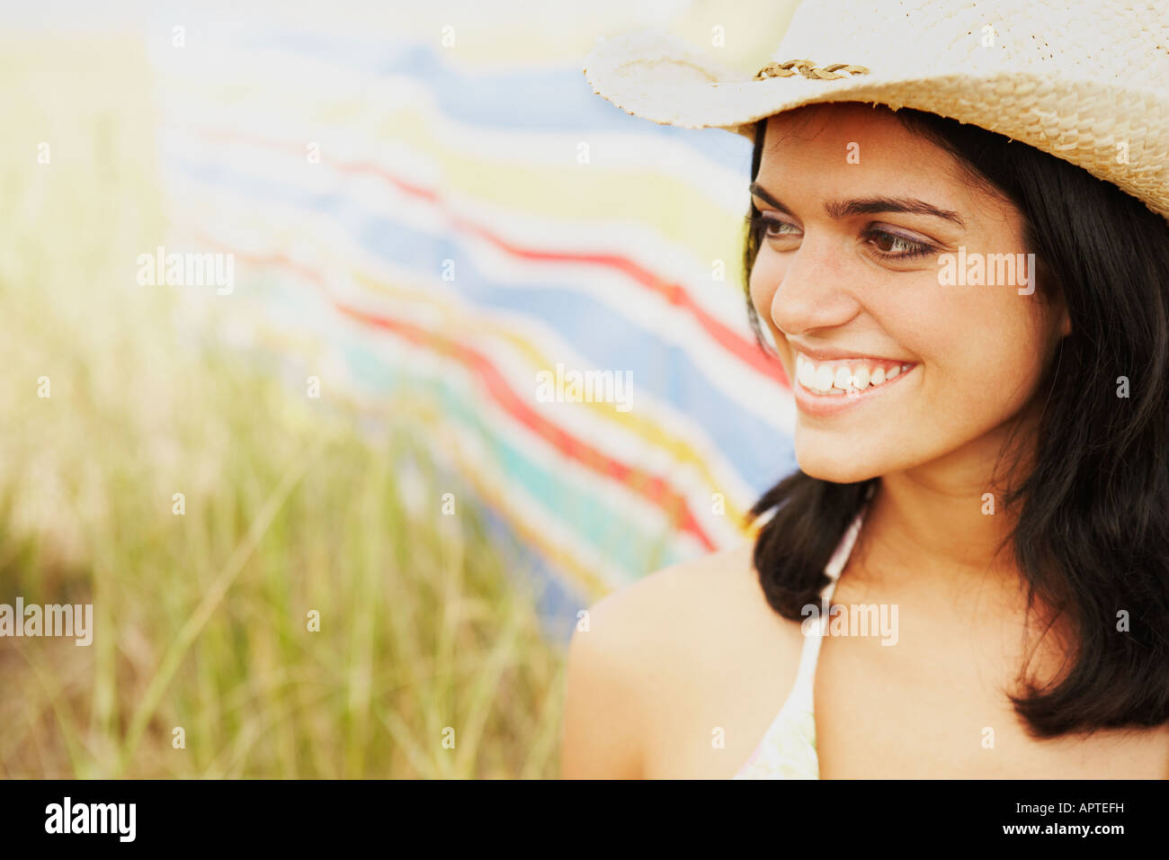 Woman wearing straw hat in field Stock Photo - Alamy