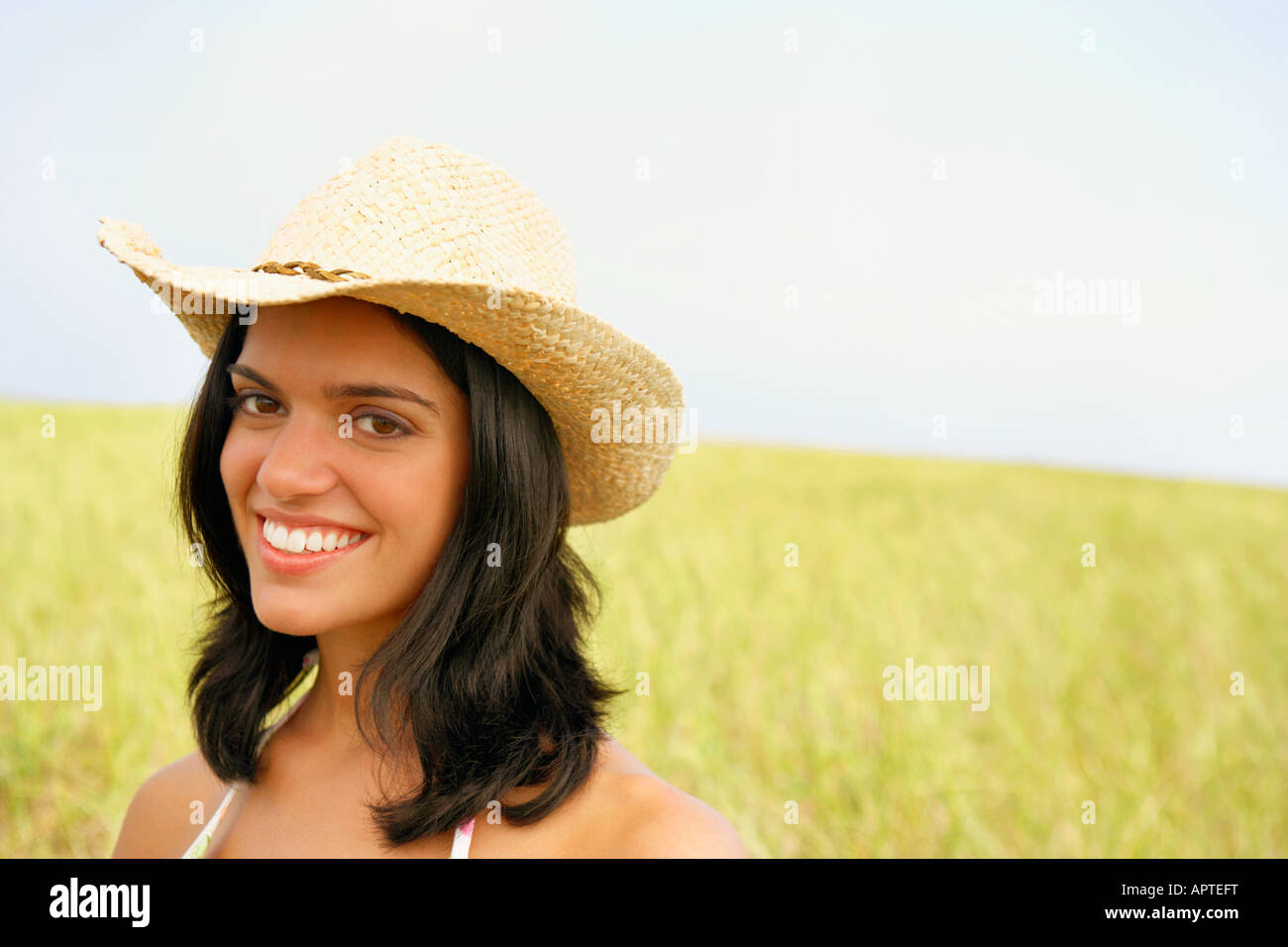 Woman wearing straw hat in field Stock Photo - Alamy
