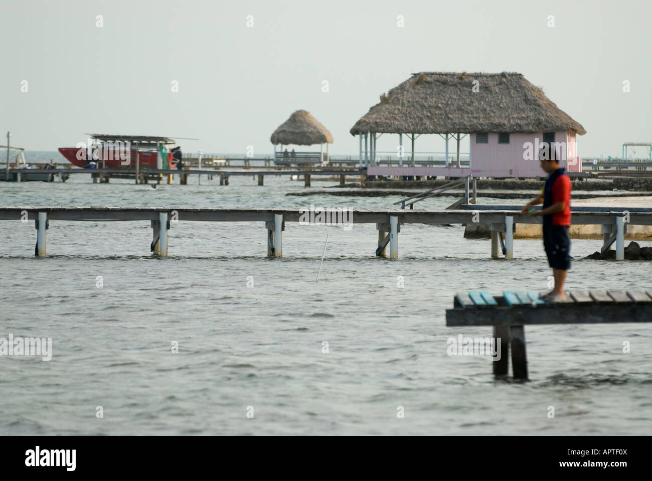 local man fishing off dock in san pedro, belize Stock Photo - Alamy