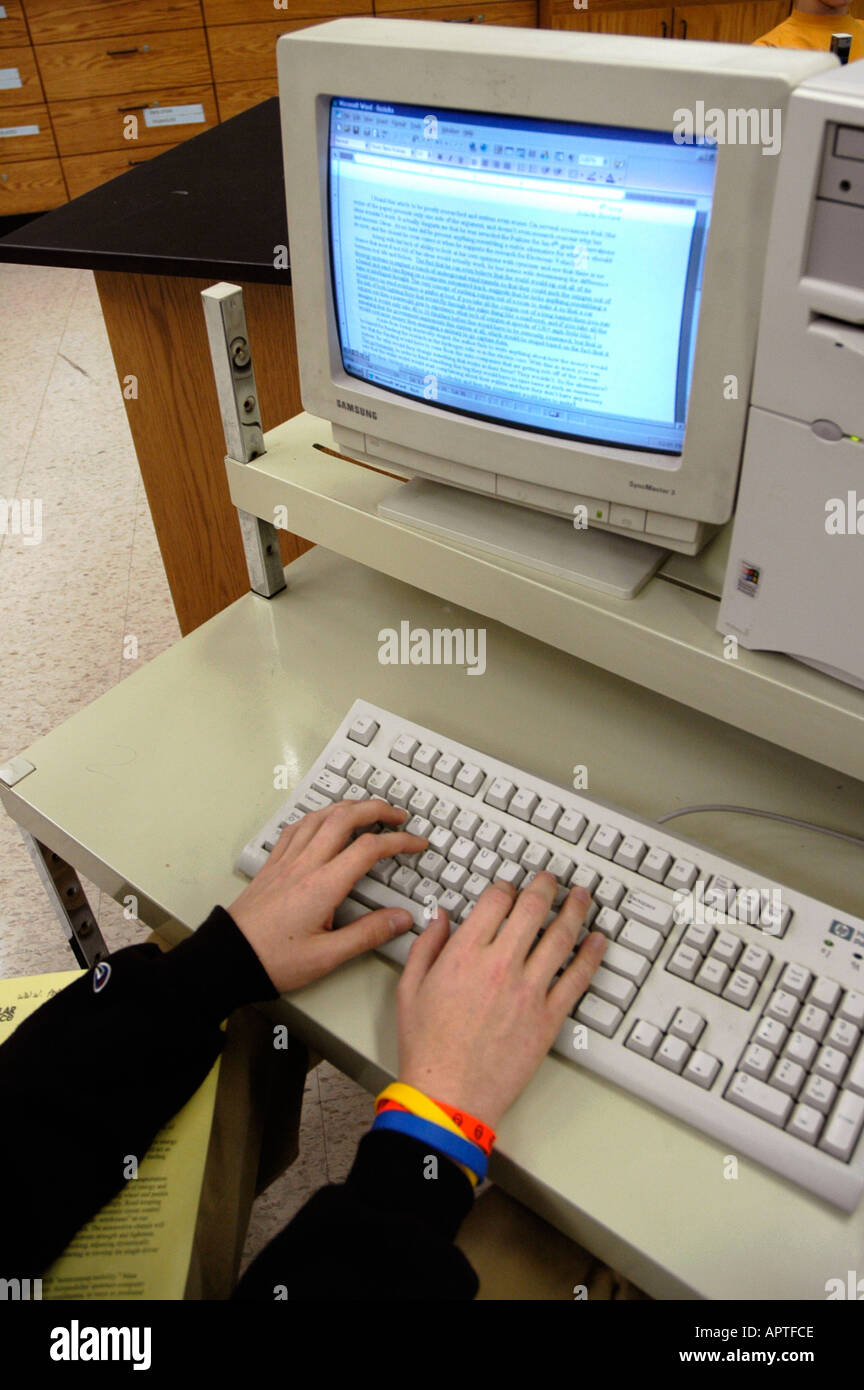 Male high school student works on a software project in a computer ...