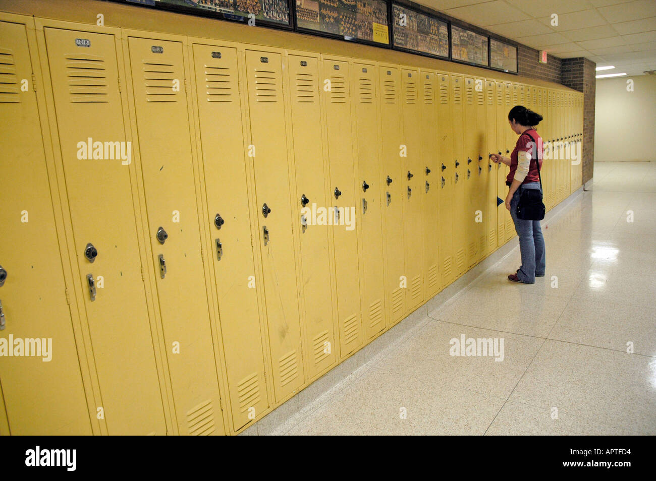 2 High school student opens combination lock on storage locker in a ...
