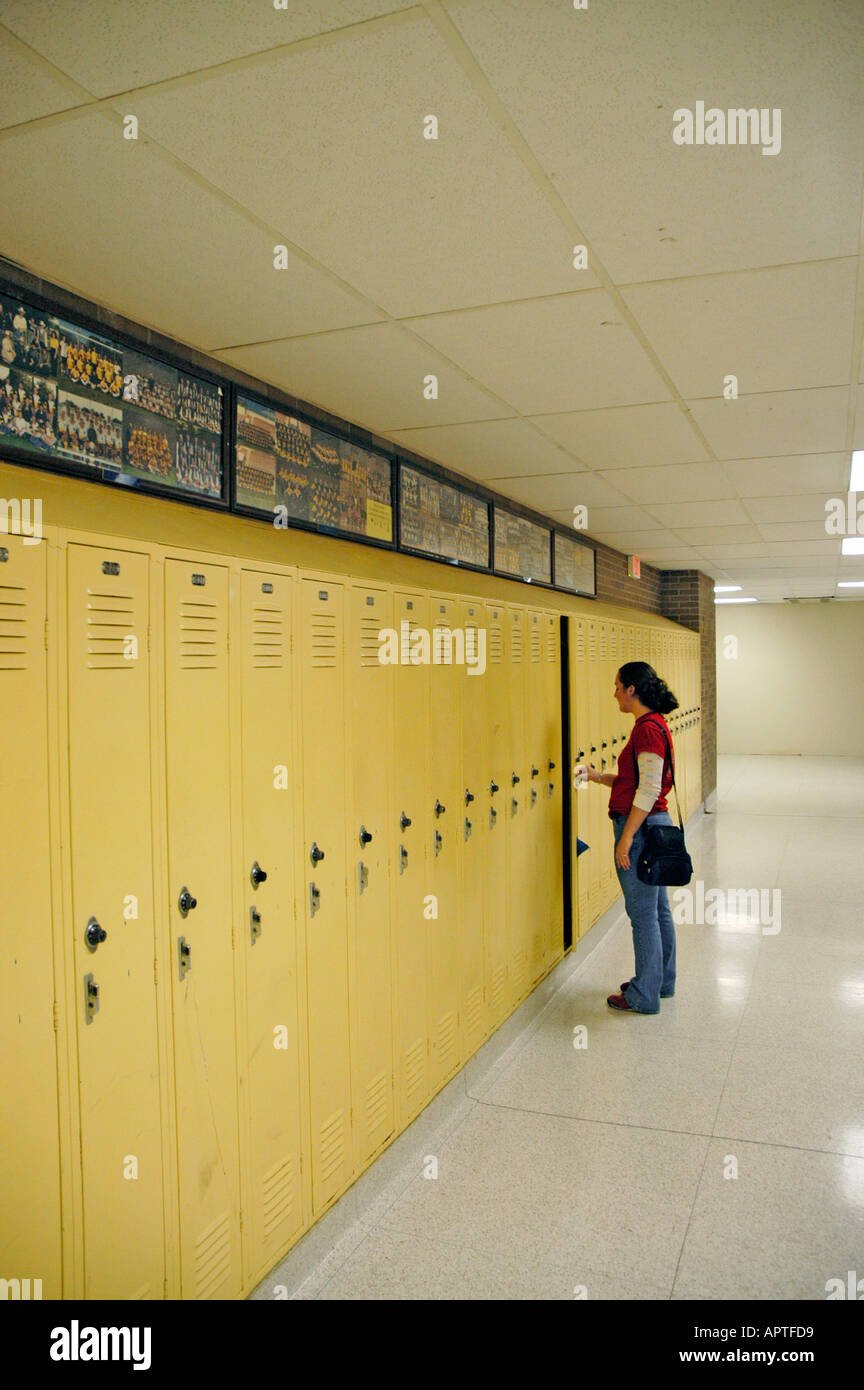 High school student opens combination lock on storage locker in a ...