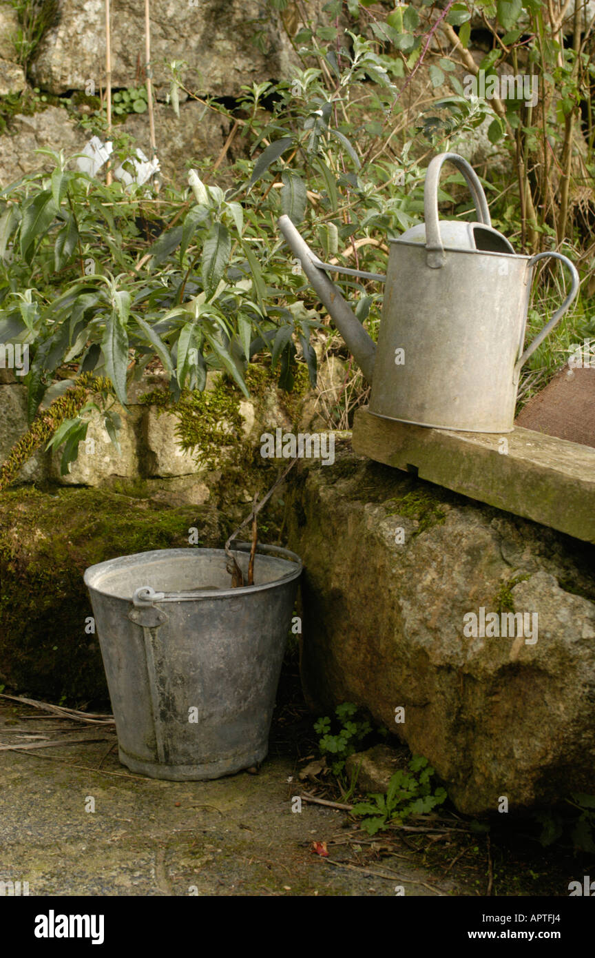 traditional metal watering can and bucket in the corner of a ...