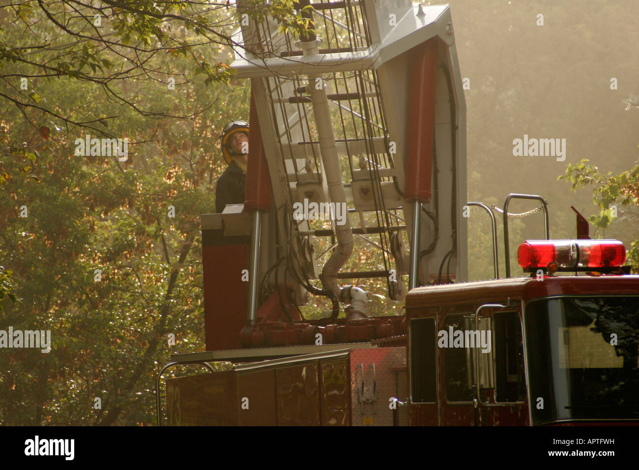 A firefighter raising and moving the ladder extension at an emergency ...