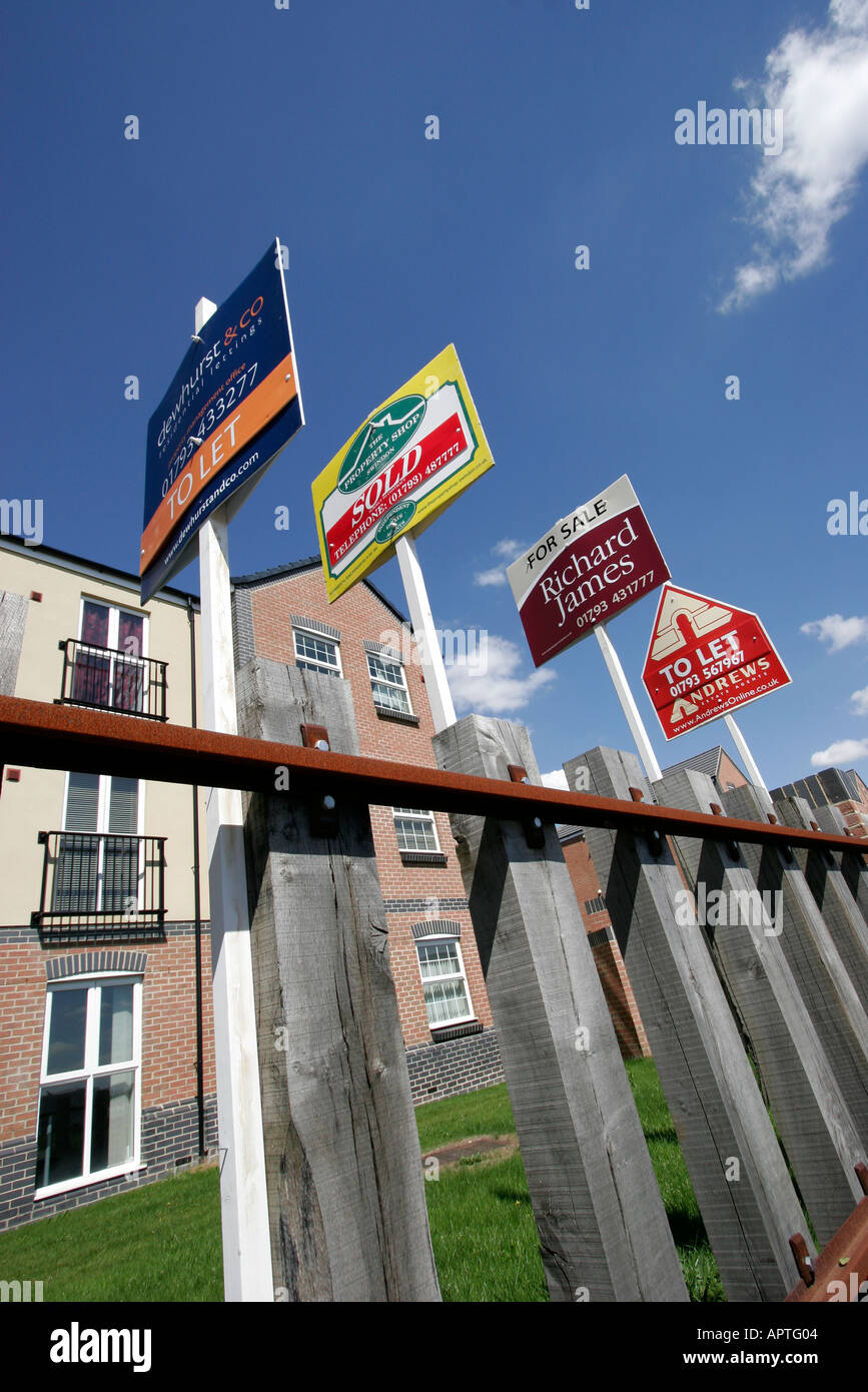 A row of estate agents signs outside newly built flats on the site of ...