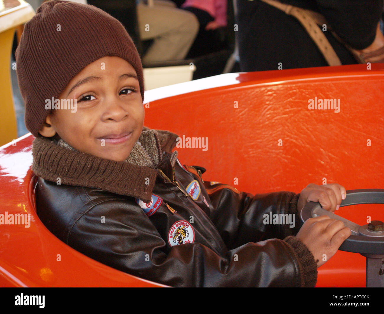 black boy ethnic child at winter fun fair ride Stock Photo - Alamy