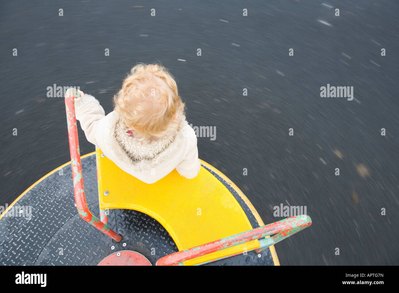 Strawberry blonde female toddler wearing winter coat on moving ...