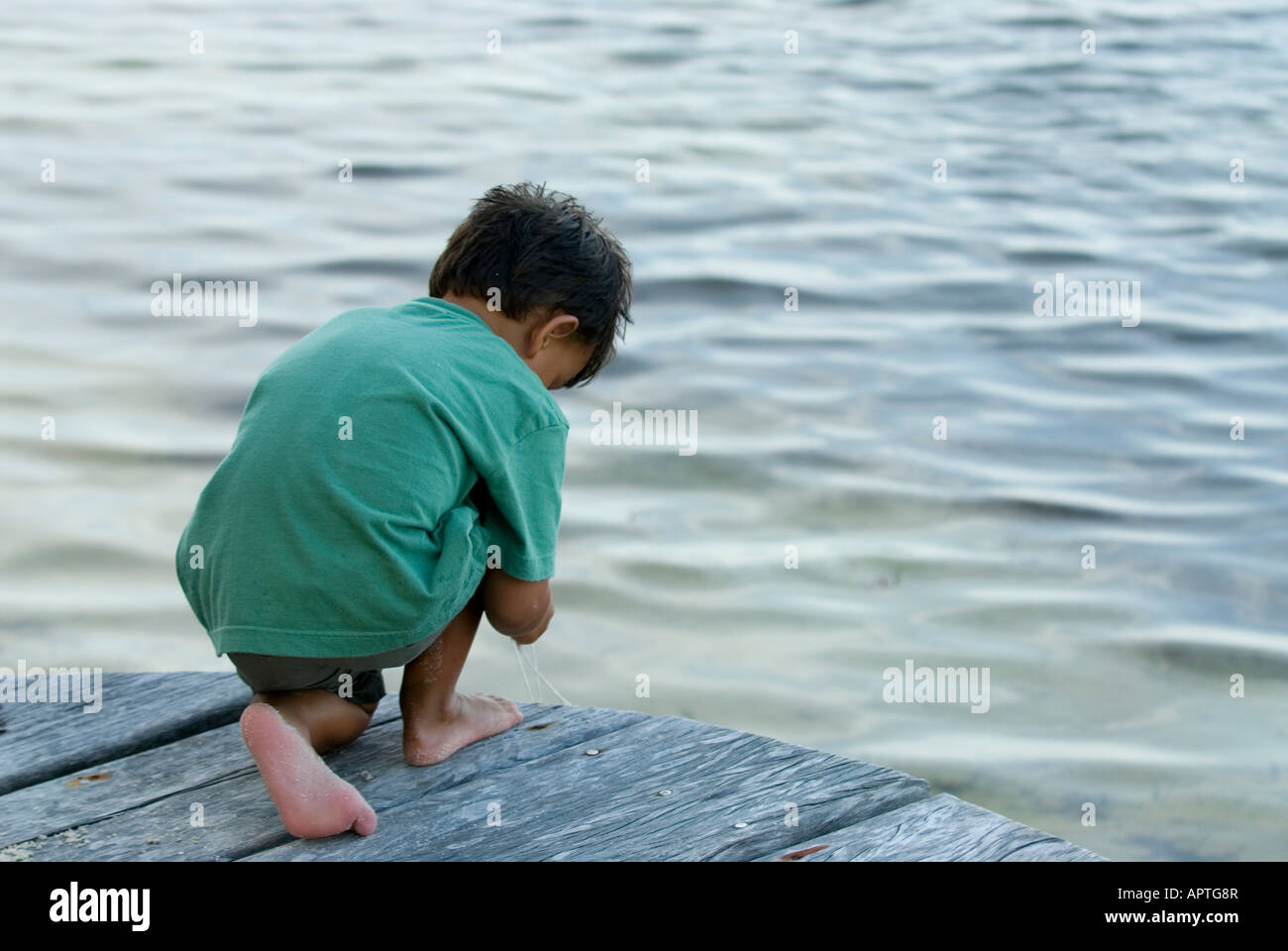 little boy exploring on a pier in Belize Stock Photo - Alamy