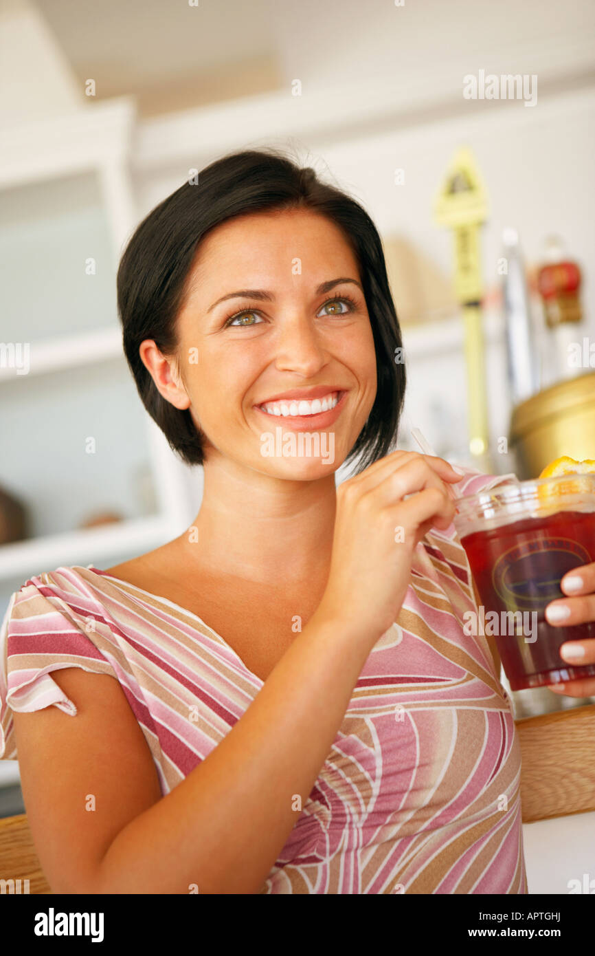 Young woman drinking at bar Stock Photo - Alamy