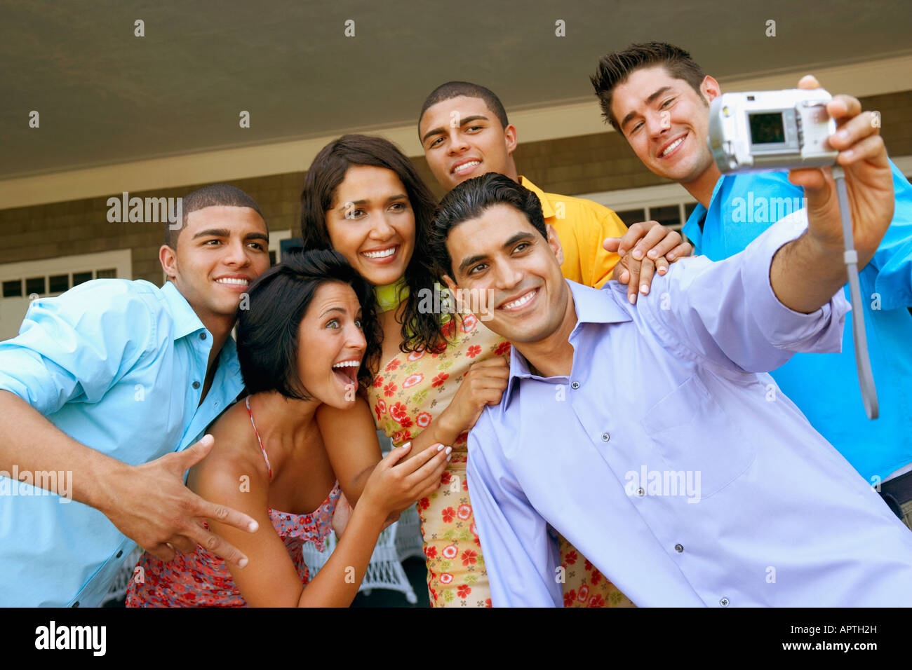Multi-ethnic friends taking own photograph Stock Photo - Alamy