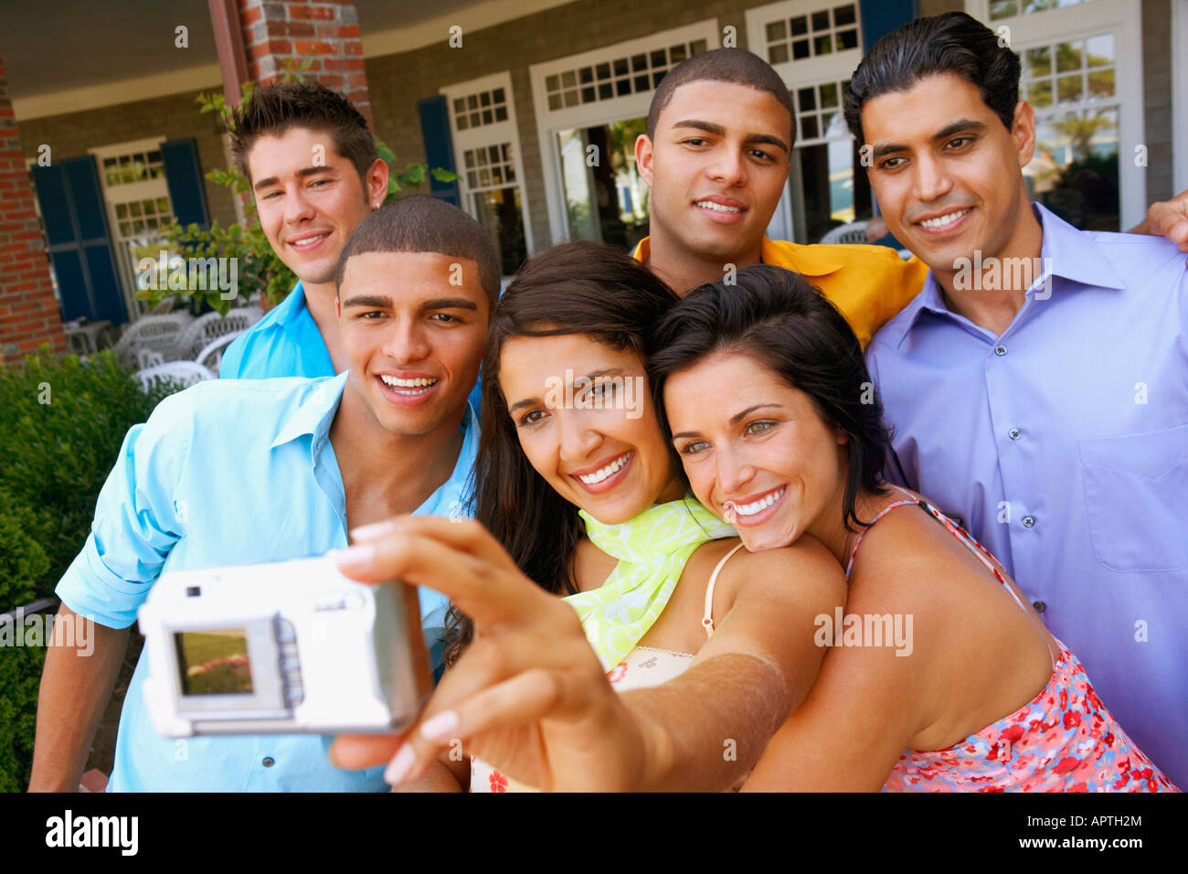 Multi-ethnic friends taking own photograph Stock Photo - Alamy
