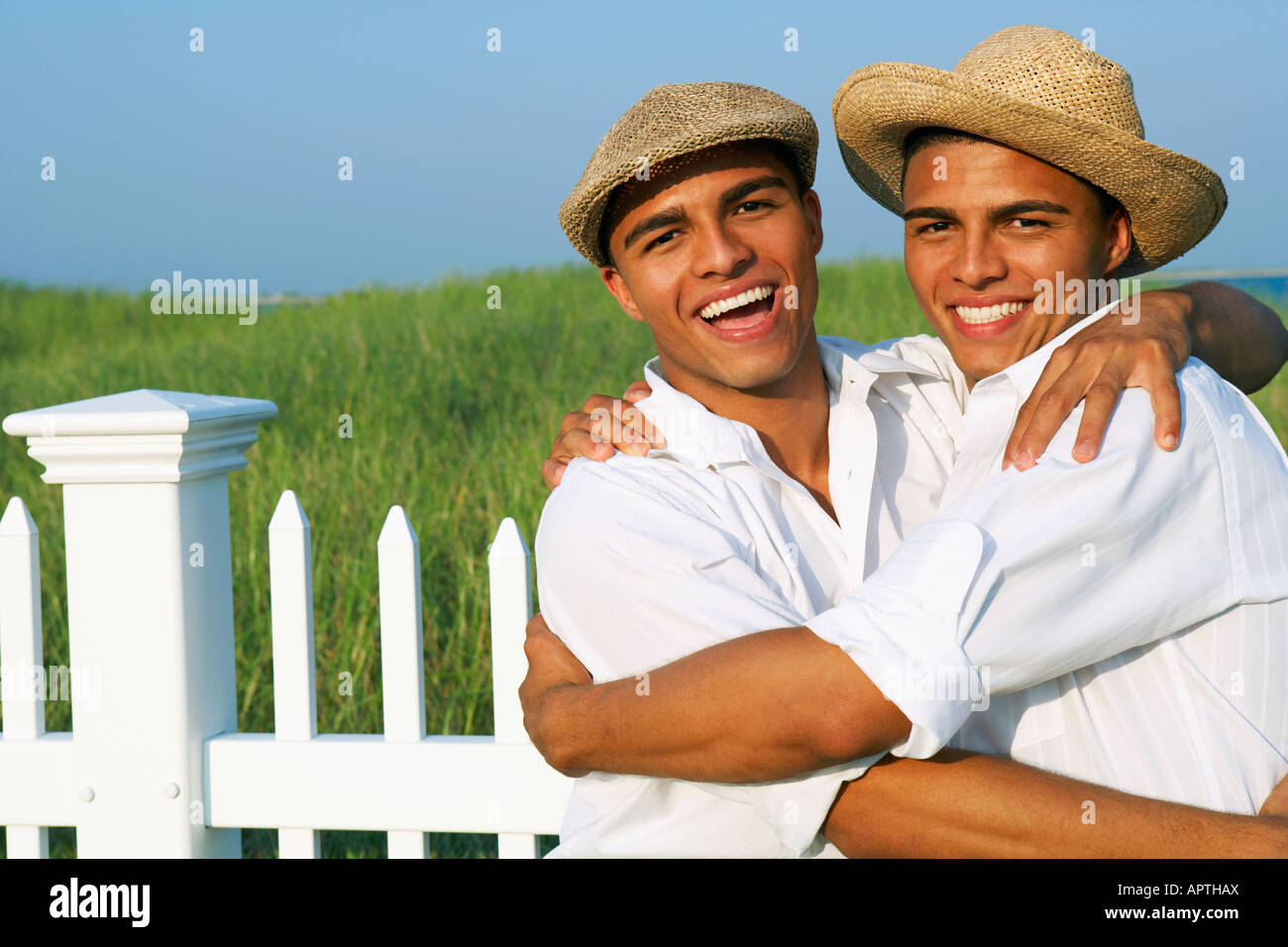 Hispanic twin brothers hugging Stock Photo - Alamy