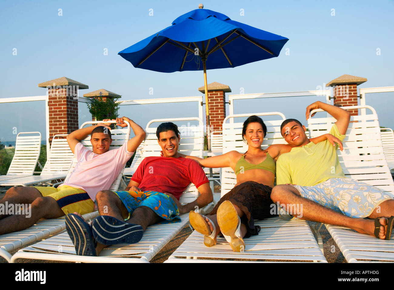 Group of friends in lounge chairs Stock Photo - Alamy
