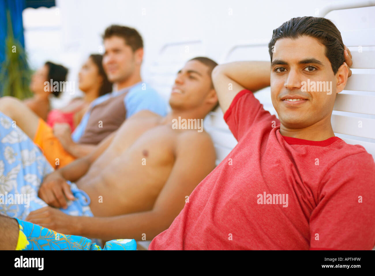 Young man in lounge chair Stock Photo - Alamy