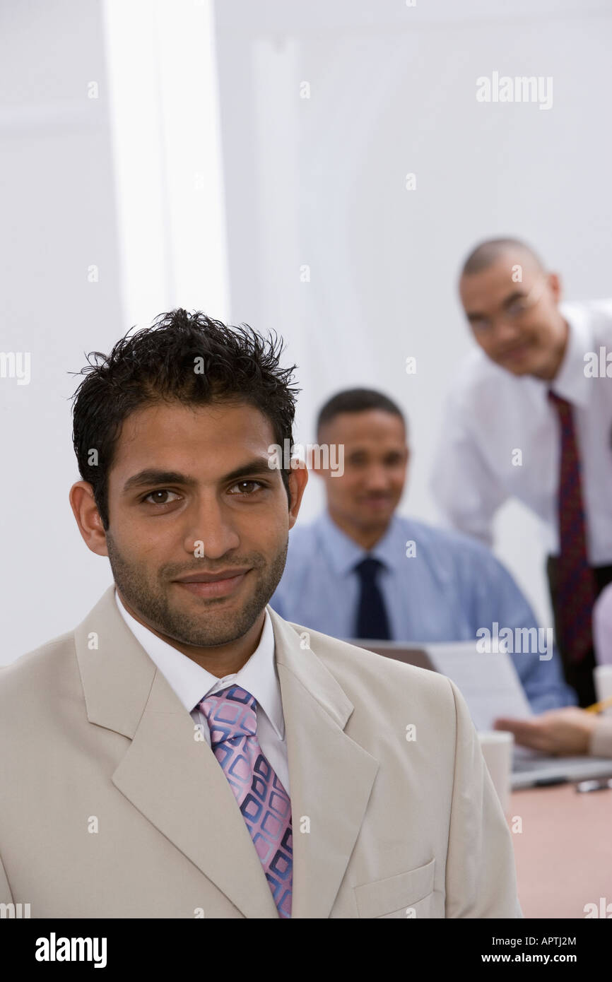 Indian businessman with co-workers in background Stock Photo - Alamy