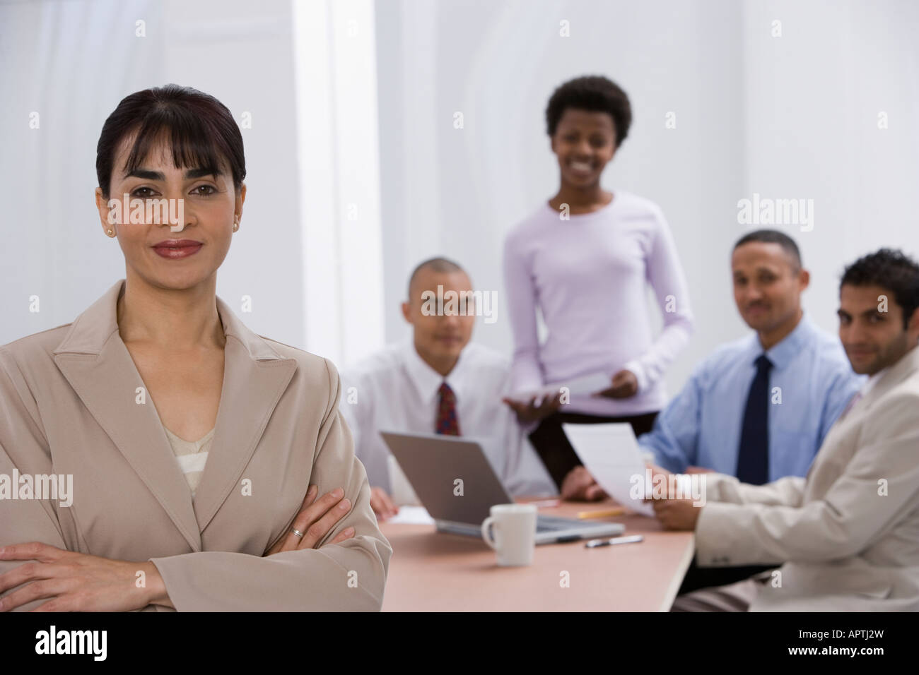 Indian businesswoman with co-workers in background Stock Photo - Alamy