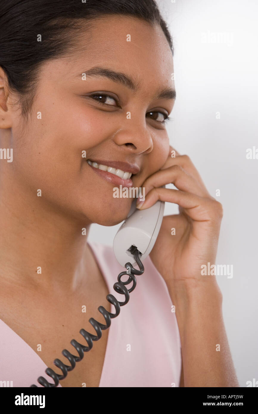 Indian woman talking on telephone Stock Photo - Alamy