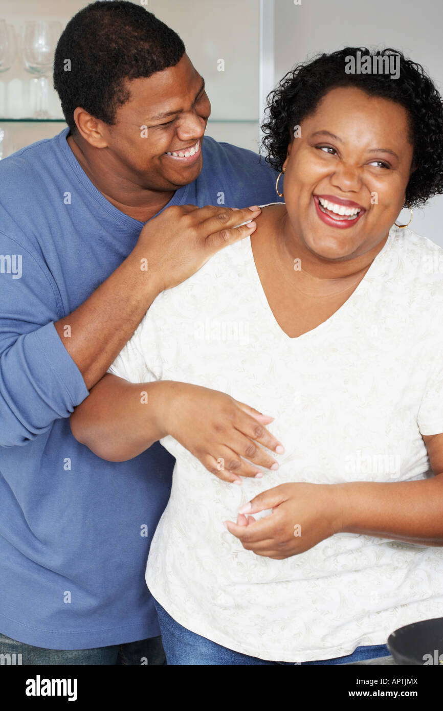 African couple hugging and laughing Stock Photo - Alamy