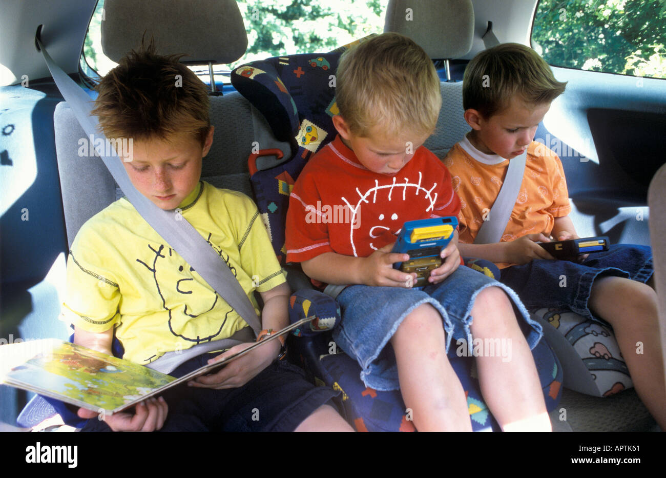 Three boys sitting in the back of a car Stock Photo - Alamy