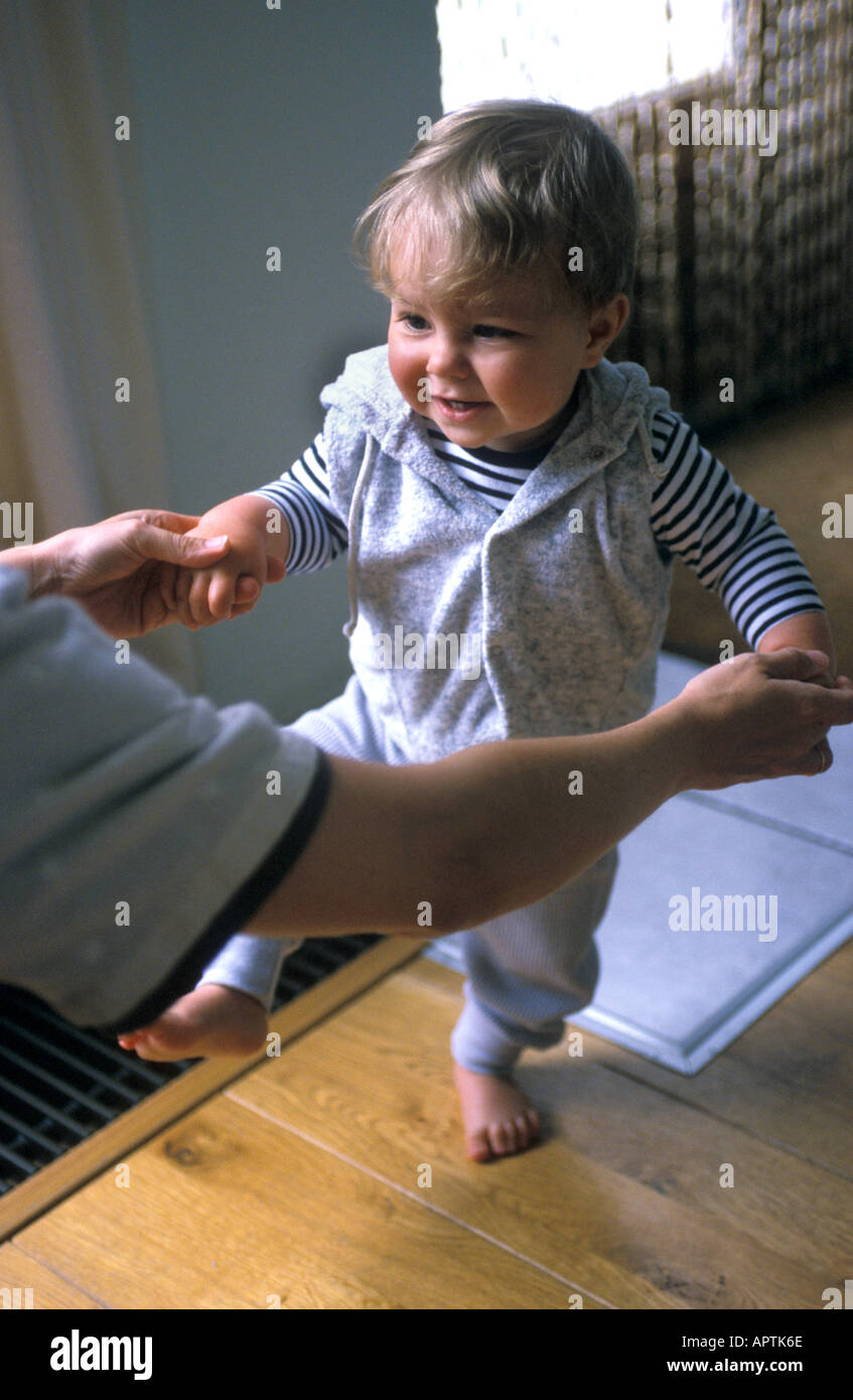 Baby first steps Stock Photo - Alamy