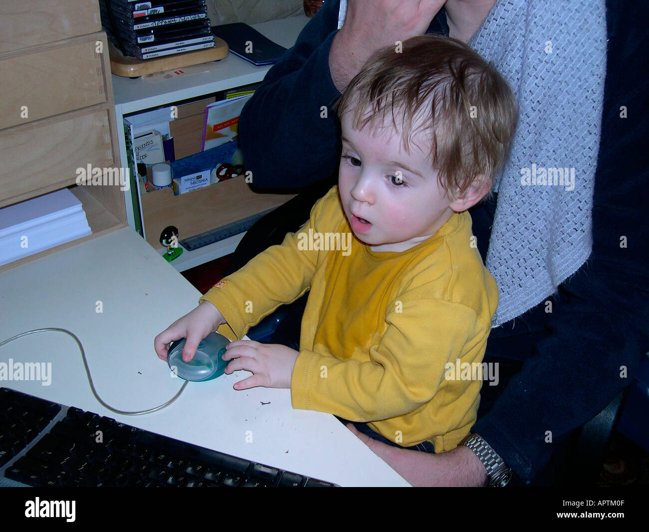 a two year old child using a mouse on a computer Stock Photo - Alamy