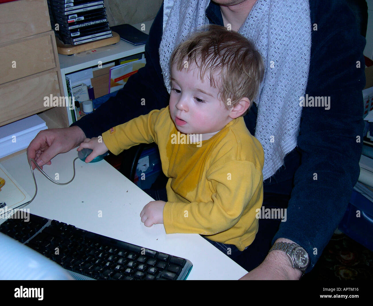 a two year old child using a mouse in a home office Stock Photo - Alamy