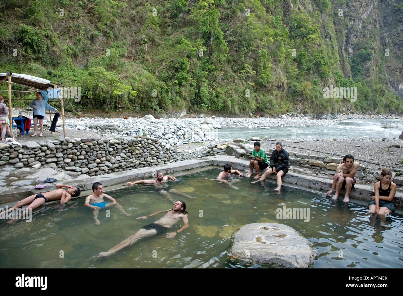 Trekkers relaxing at hot springs. Tatopani village. Annapurna circuit ...