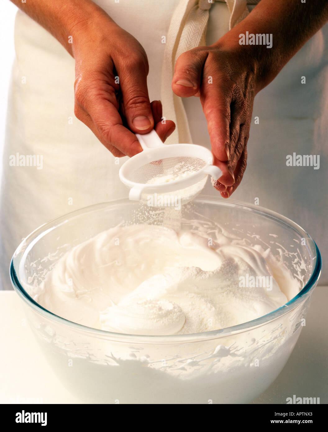 Steps to making pavlova - sift corn flour over the meringue then fold ...