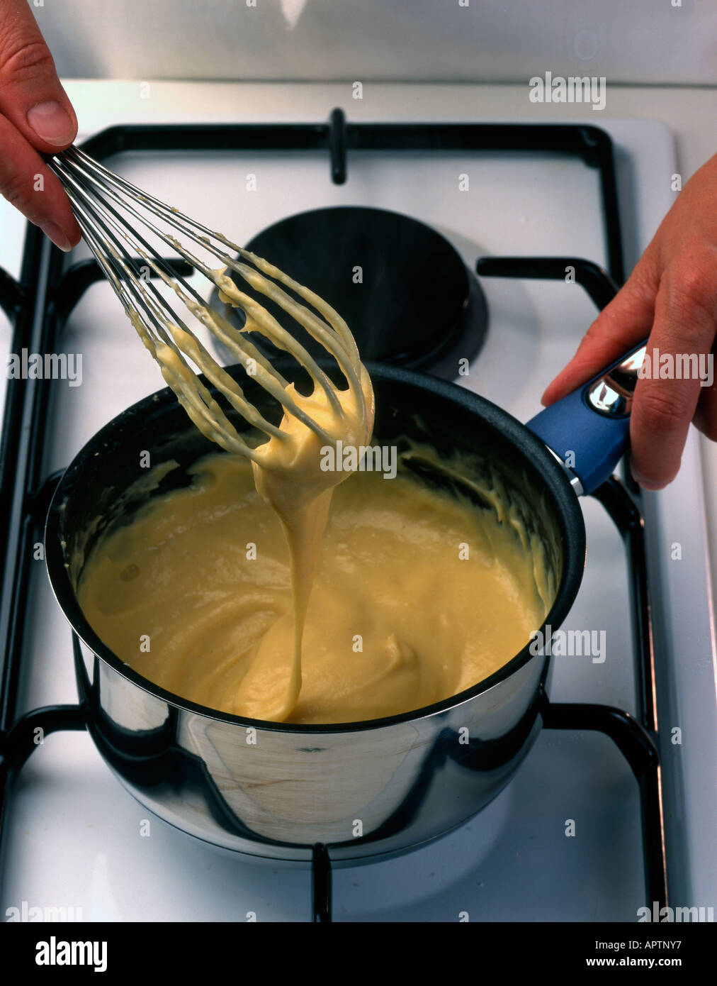 making savoury egg sauce - hollandaise - whisking butter into egg yolk ...