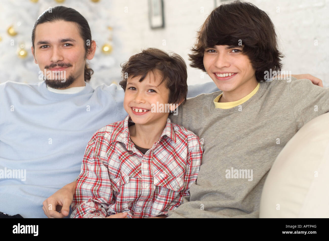 Hispanic brothers sitting on sofa Stock Photo - Alamy