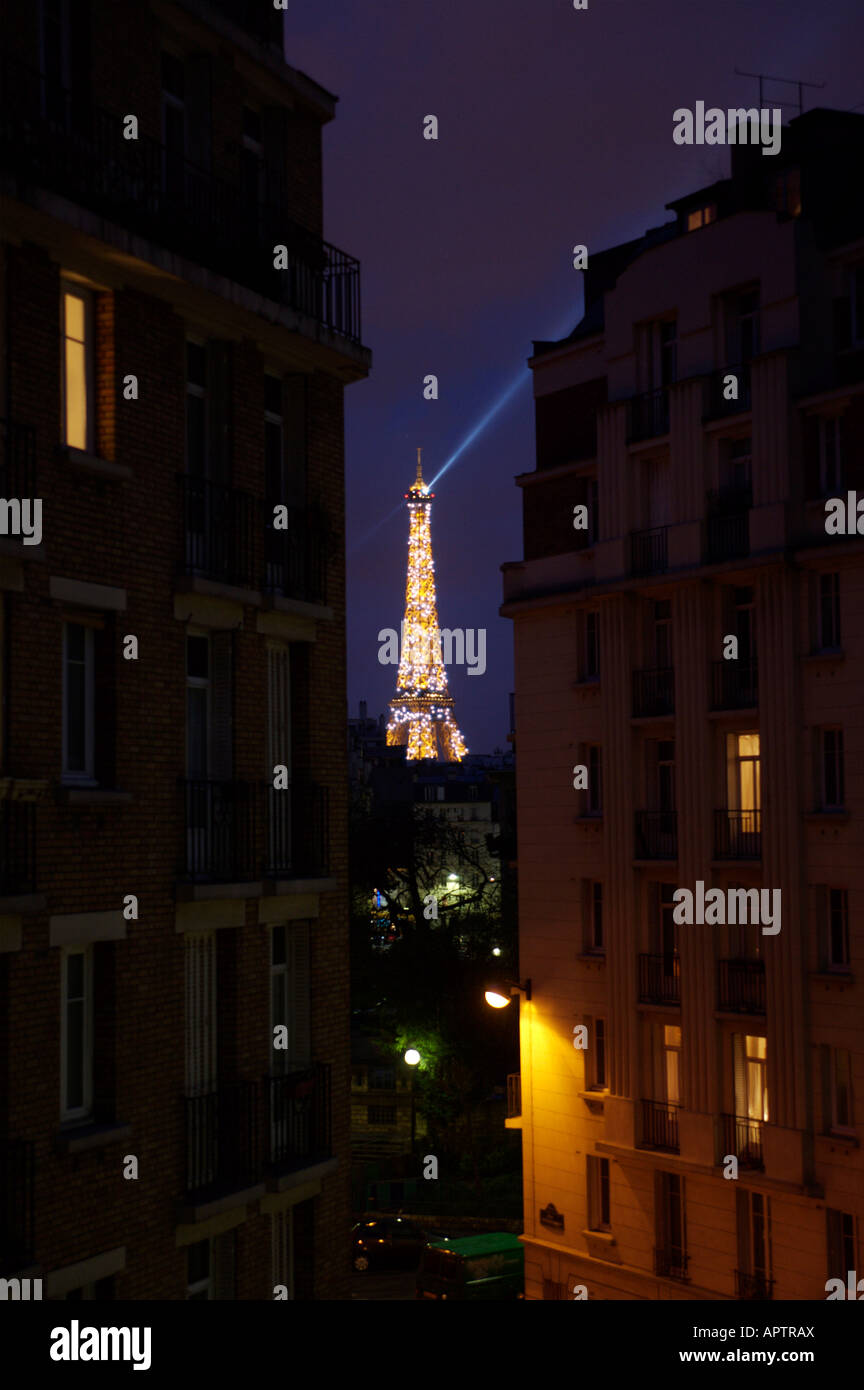 Eiffel Tower standing between two Parisian apartment blocks Stock Photo ...