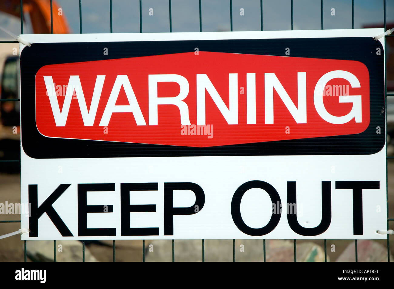 Warning Keep Out sign on a construction site fence Stock Photo - Alamy