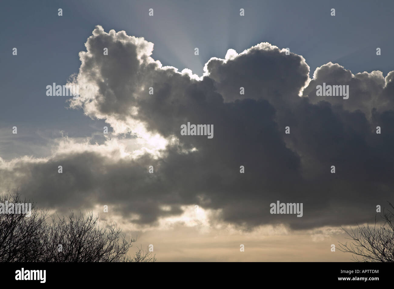 Rays of sun beaming through dark low cumulus cloud in winter Stock ...