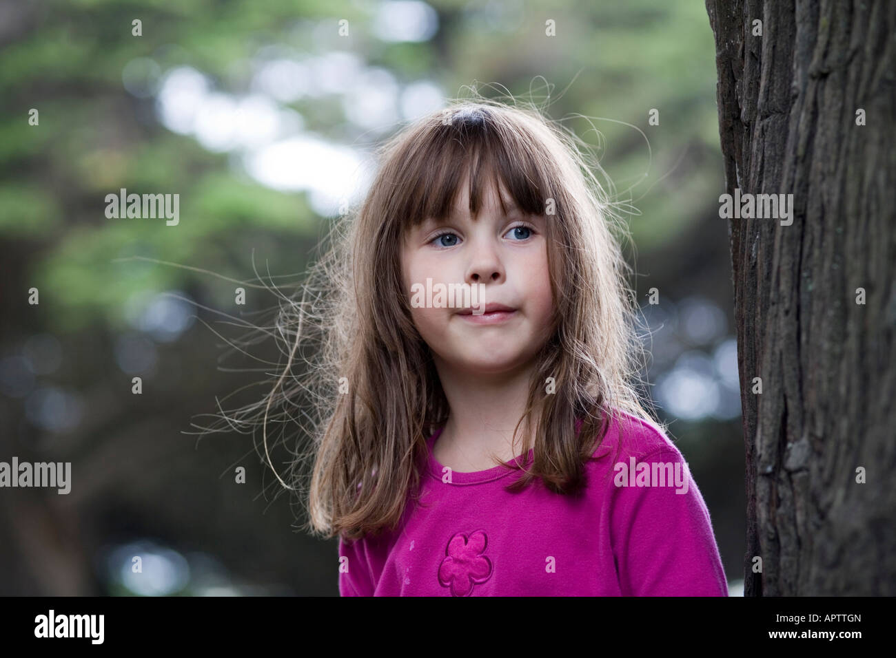 Girl next to tree Stock Photo - Alamy