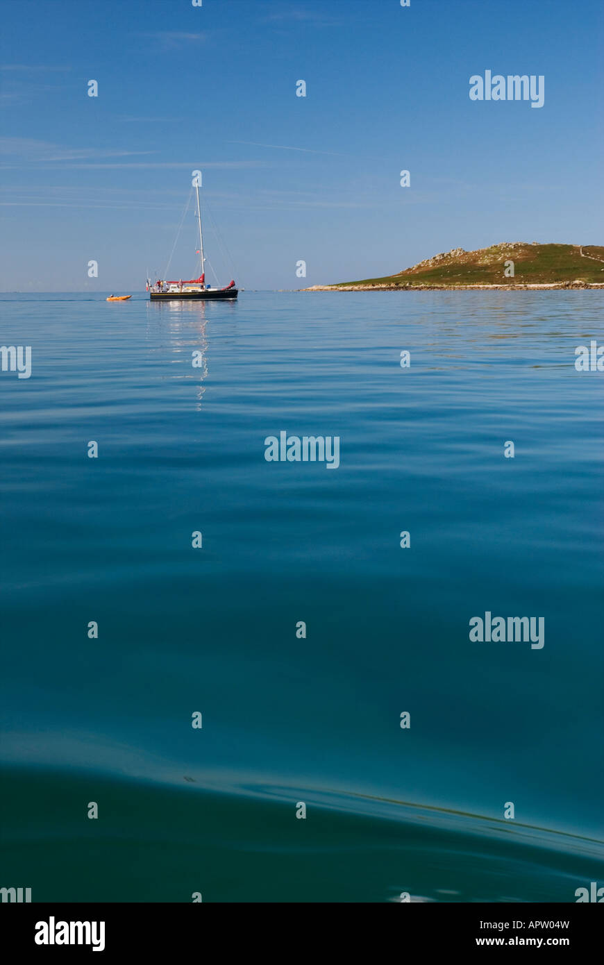 Yacht passing Samson Island in the Scilly Isles England UK Stock Photo ...