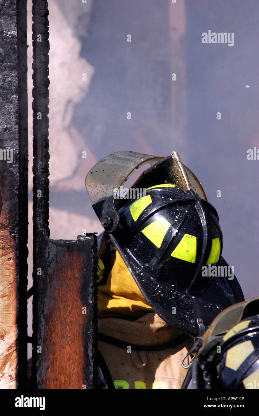 Two firefighters extinguishing a structure fire Stock Photo - Alamy