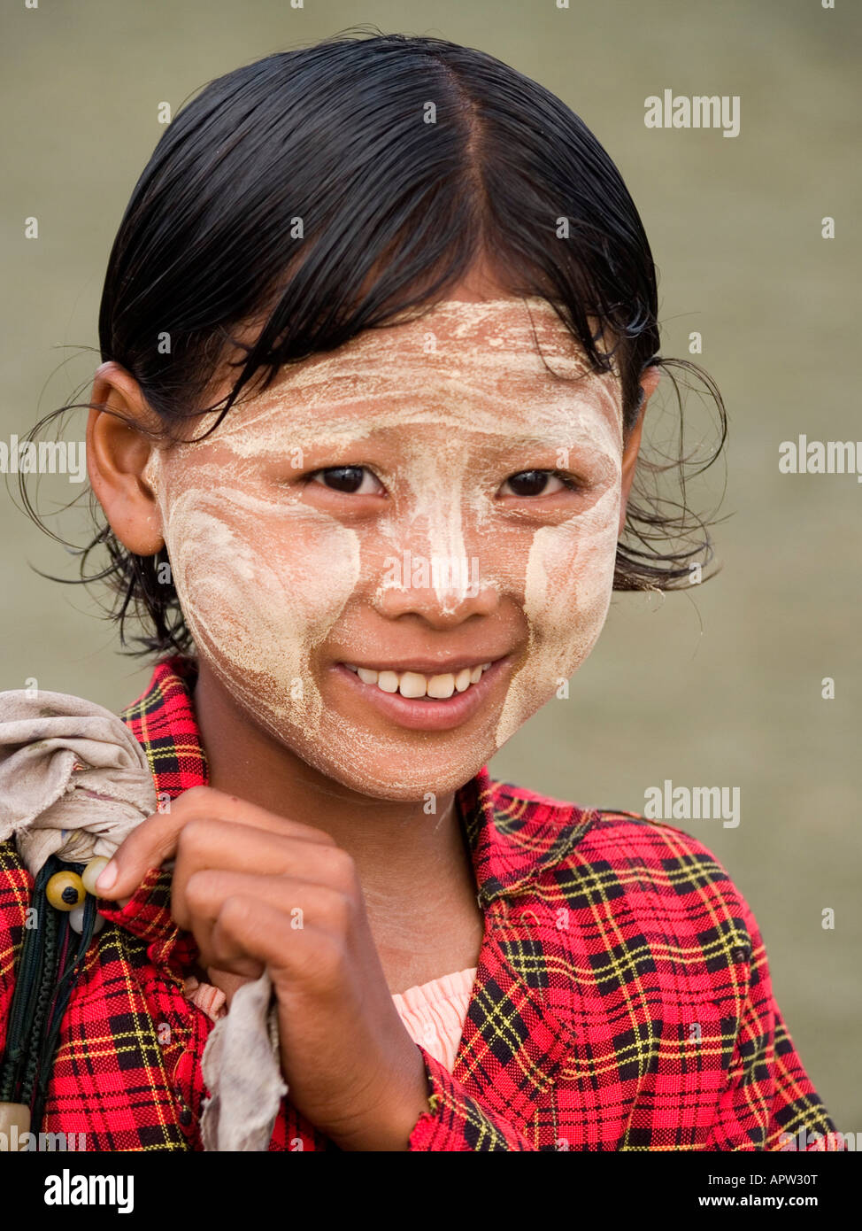 portrait of al young smiling Burmese girl with thanaka face paint Stock Photo - Alamy