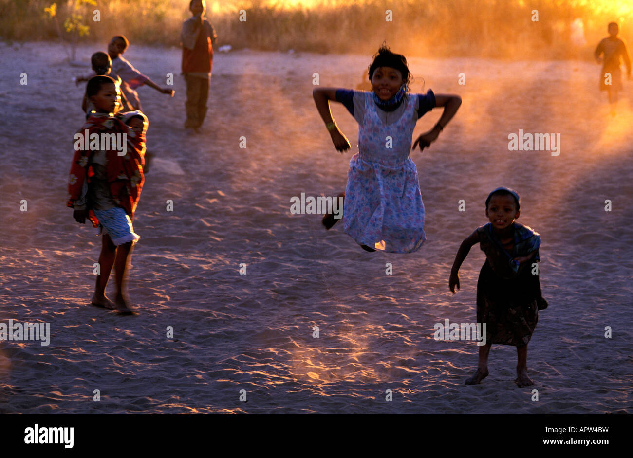 Jump Bushman children playing in the sand Den ui village Bushmanland ...
