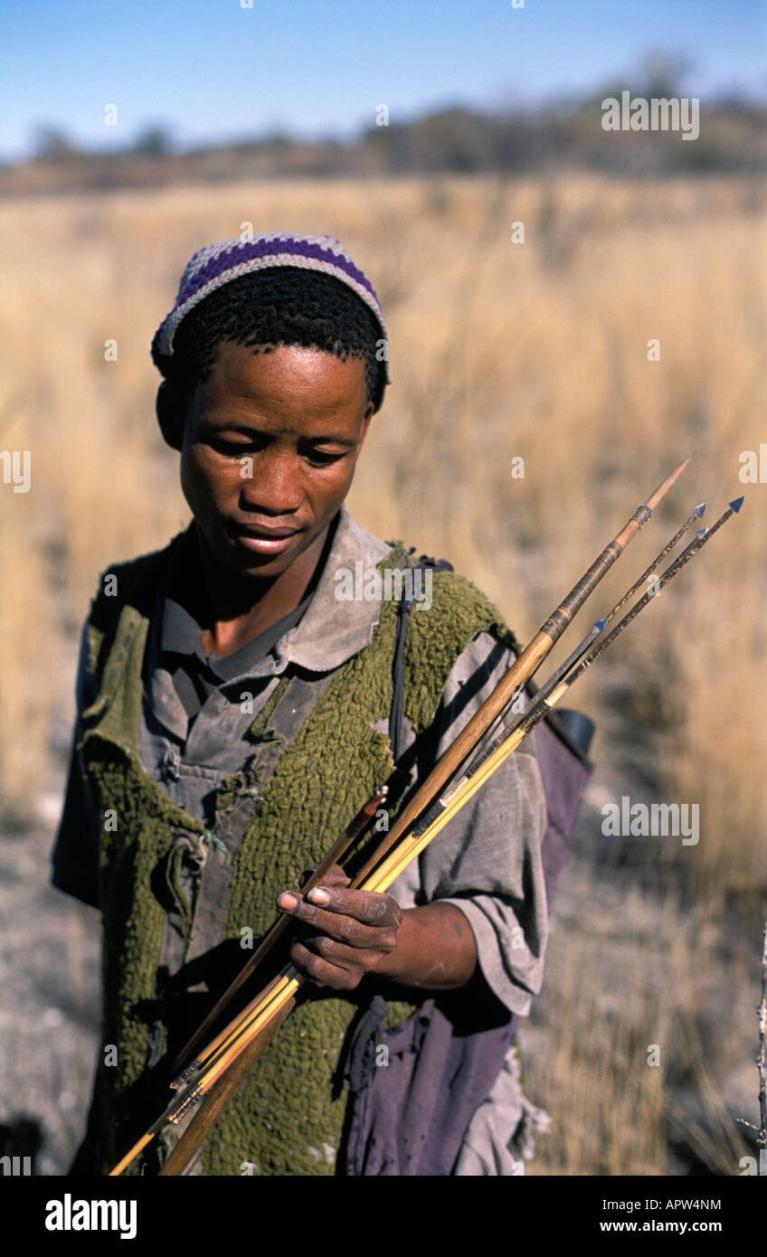 Bushman hunter checks his arrows before leaving for hunt Namibia Stock ...