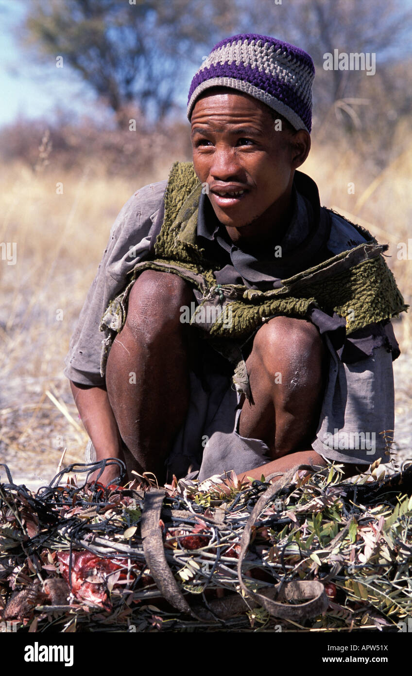 Bushman hunter packing his share of Oryx meat after successful hunt ...