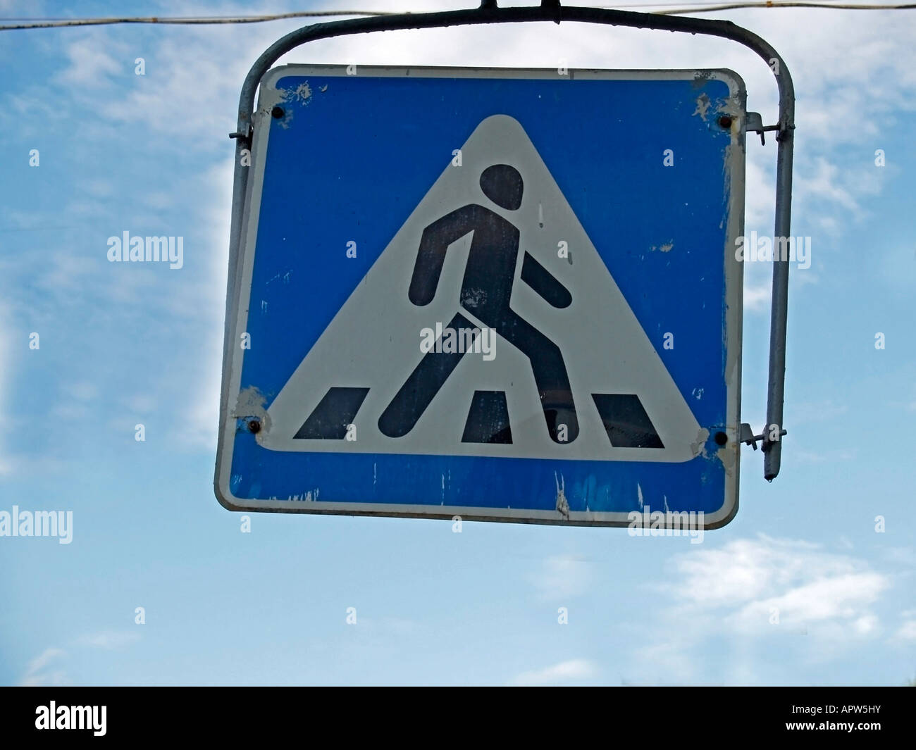road sign for crosswalk pedestrian crossing against blue sky Saint ...